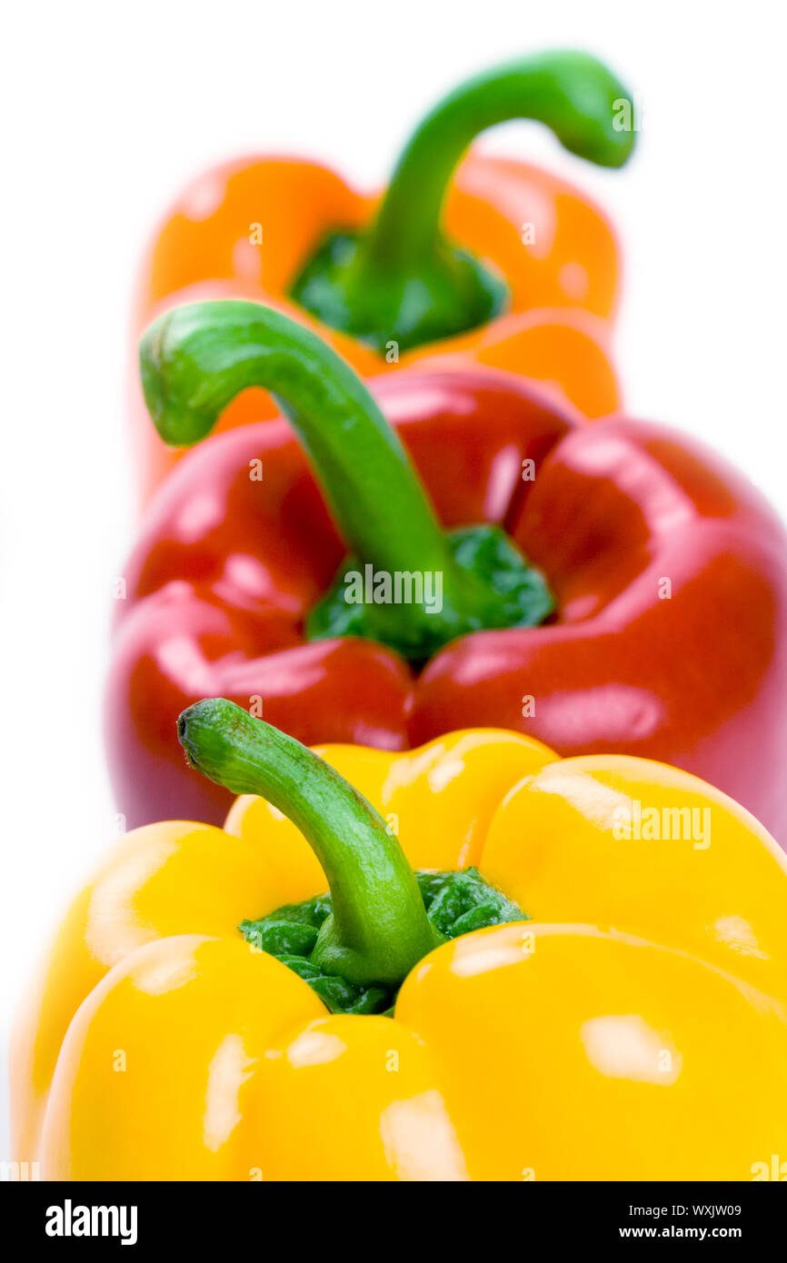 three bell peppers closeup on white background Stock Photo - Alamy