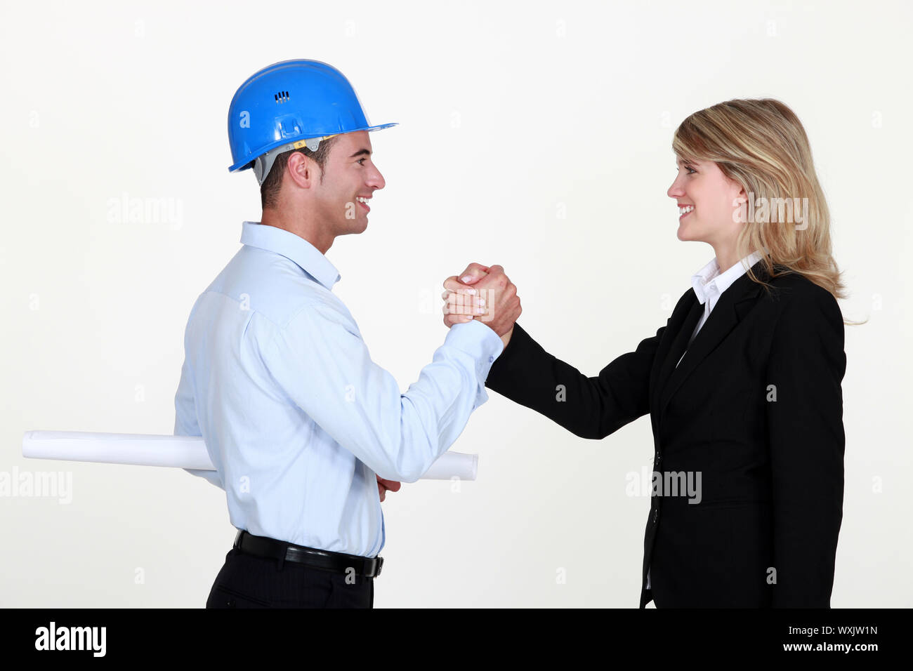 Two architects greeting each other Stock Photo - Alamy