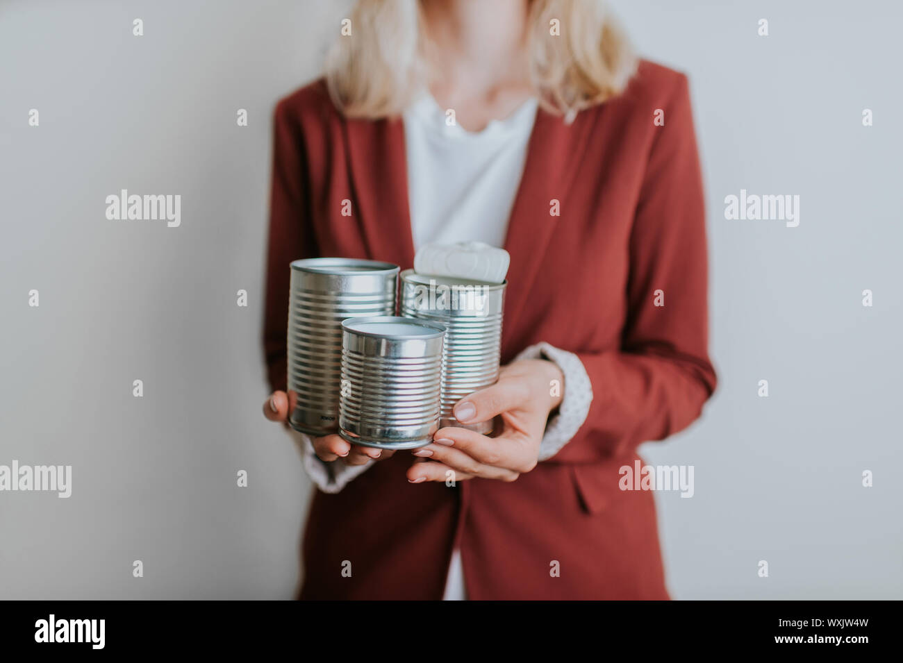 Woman holding tin cans hi-res stock photography and images - Alamy