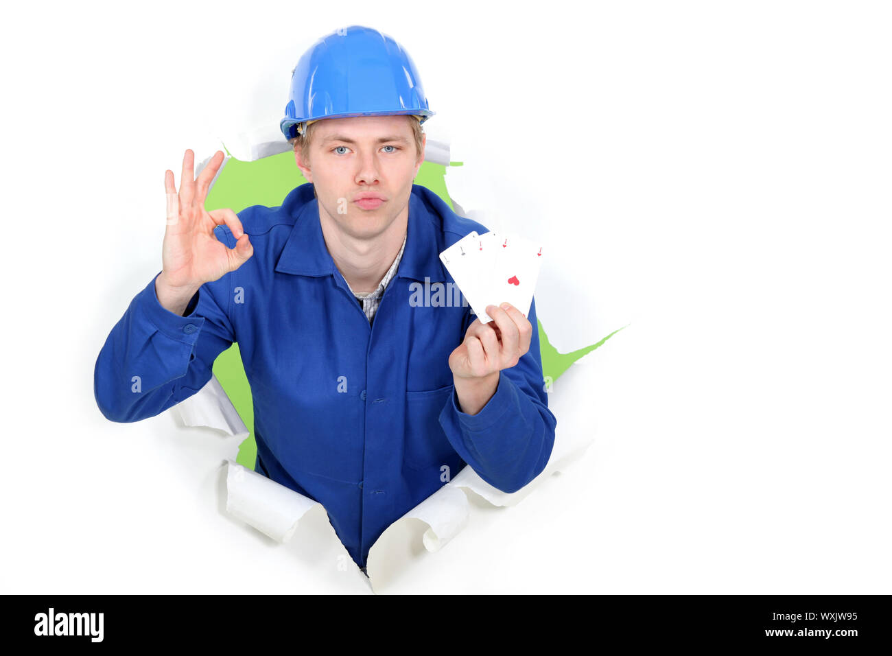 Tradesman giving the a-ok sign and holding up cards Stock Photo - Alamy