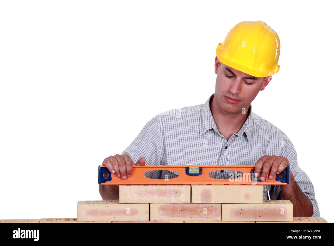 mason working with a level Stock Photo - Alamy