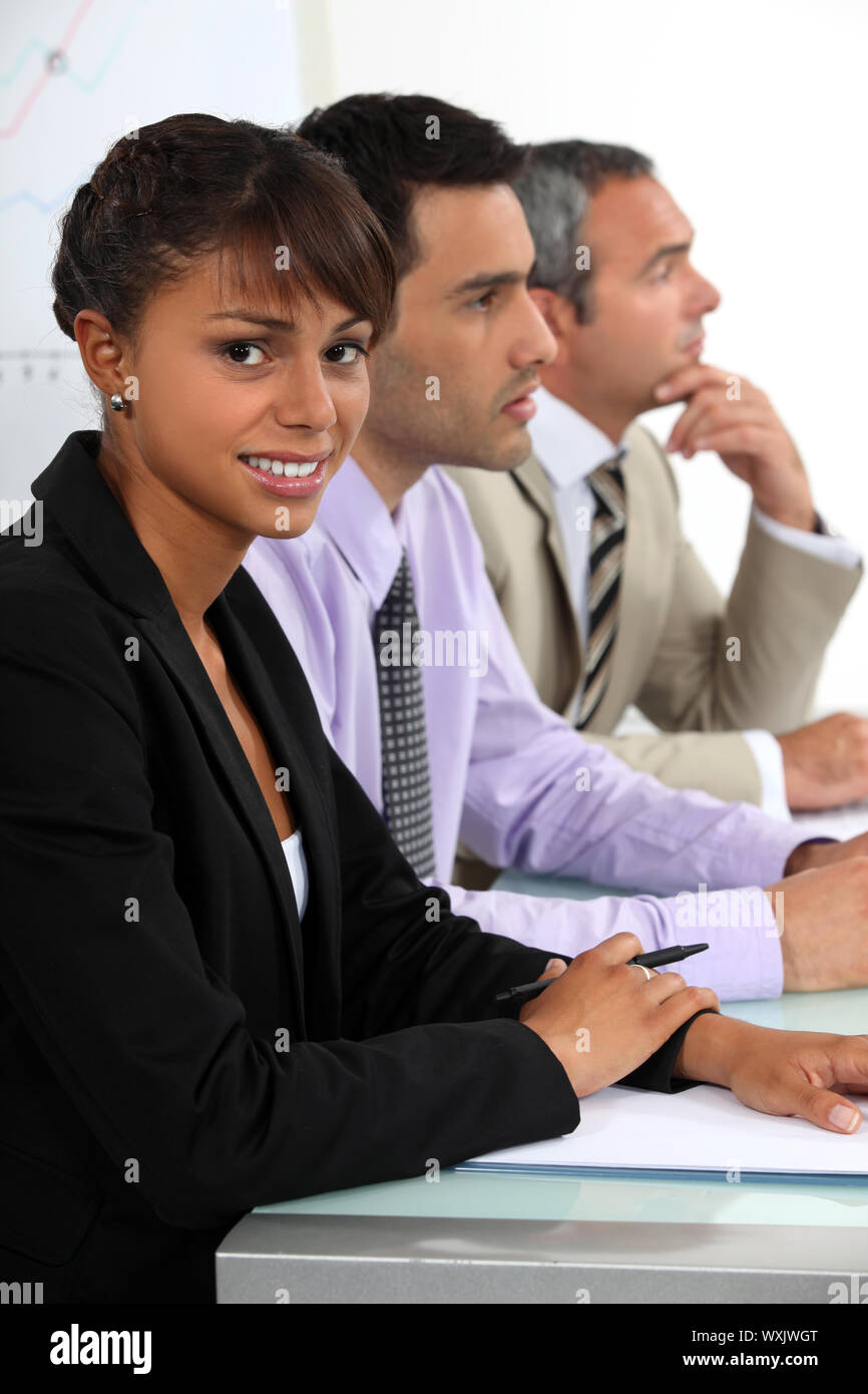Three people sat on interview panel Stock Photo - Alamy