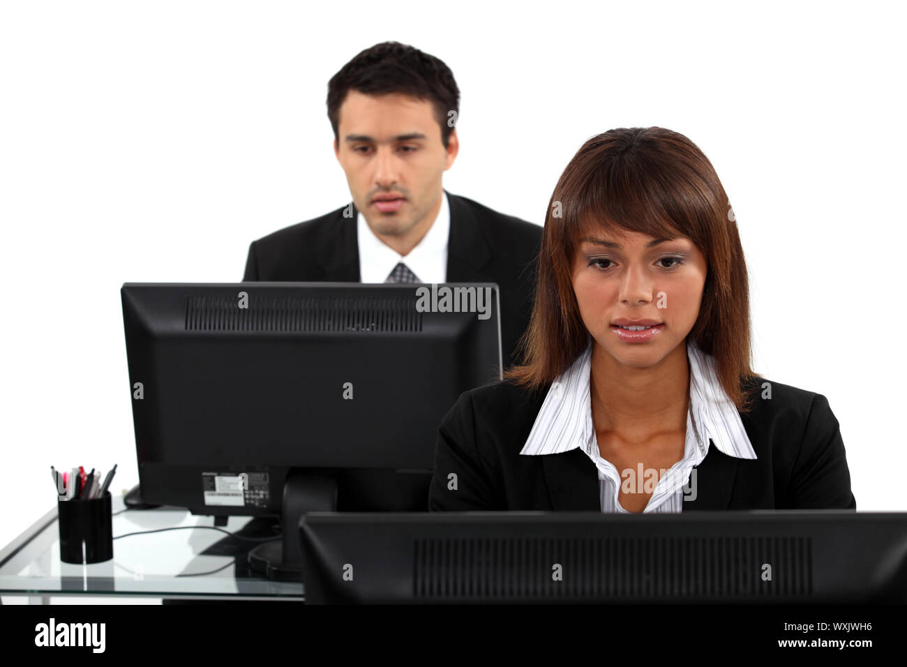 Two office workers sat at their desks Stock Photo - Alamy
