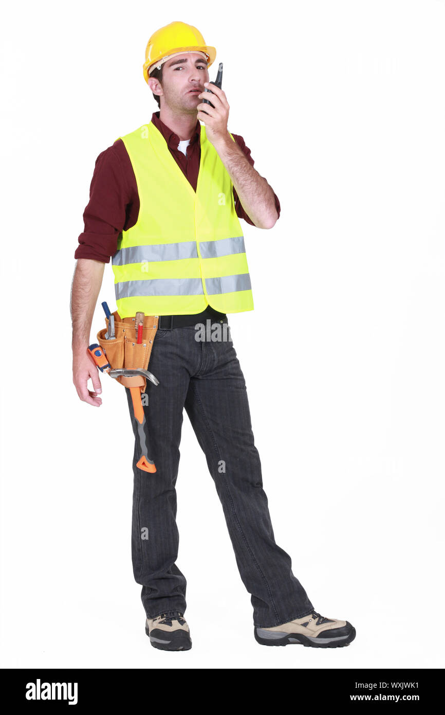Workman using walkie-talkie on white background Stock Photo - Alamy