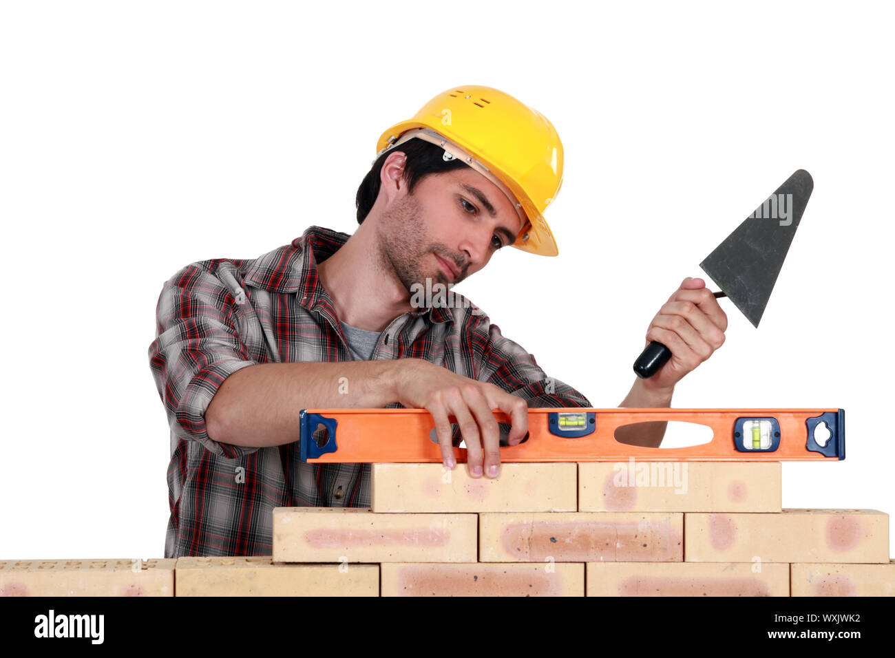 A mason using a level Stock Photo - Alamy