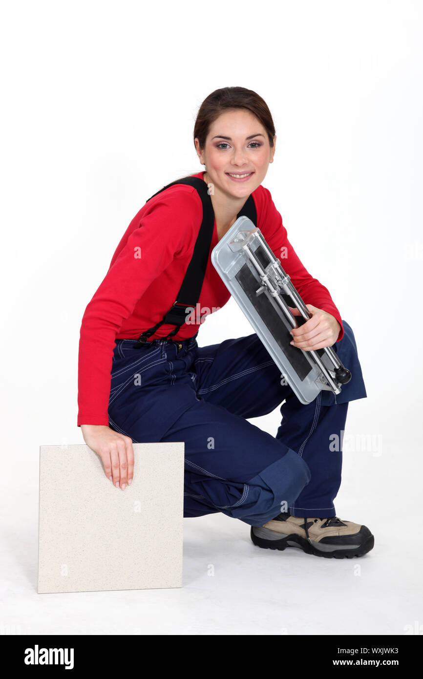 female tiler posing against white background Stock Photo - Alamy