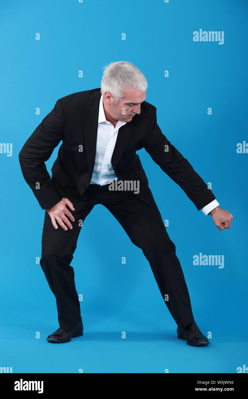 Businessman pulling an imaginary object Stock Photo - Alamy
