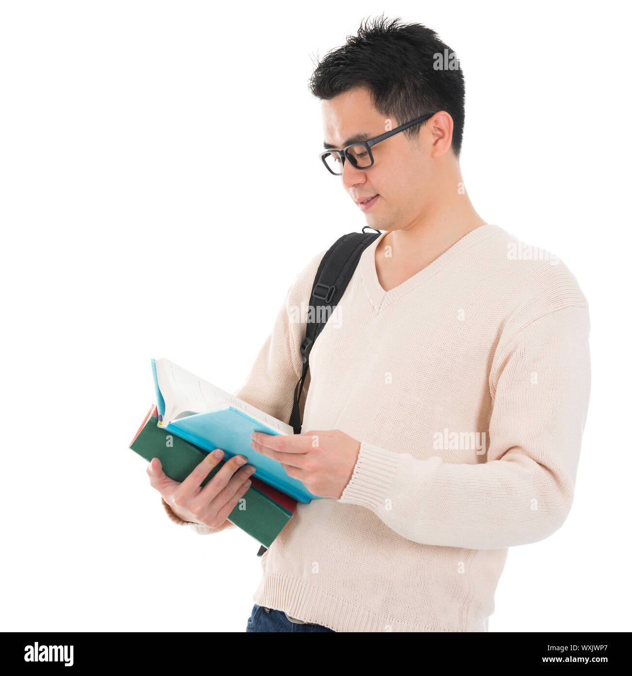 Asian adult student in casual wear with school bag carrying text books ...