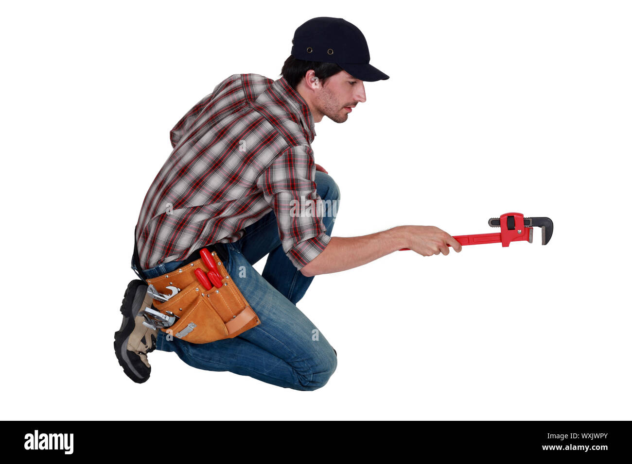 Plumber using adjustable wrench Stock Photo - Alamy
