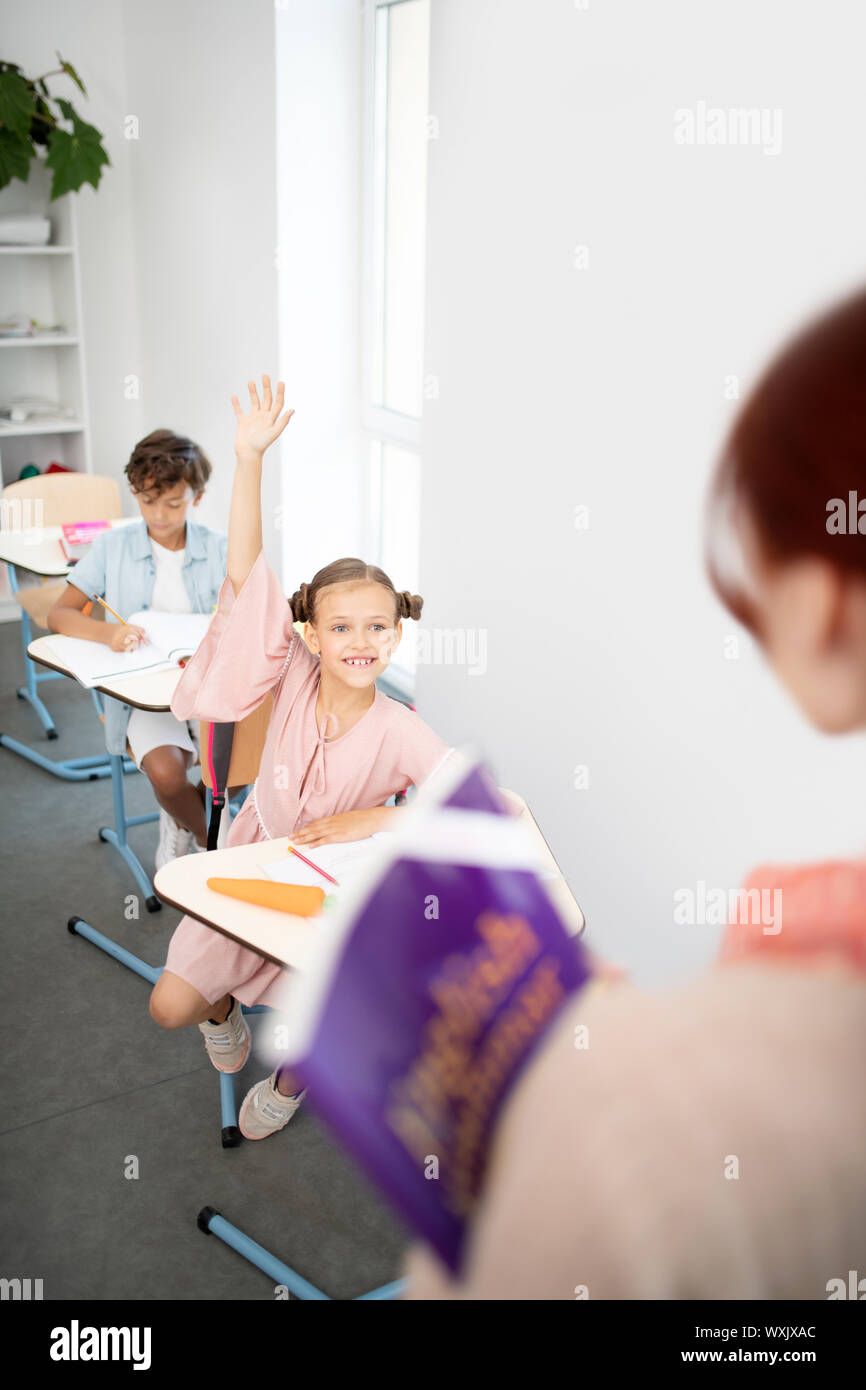 Active schoolgirl knowing the answer for difficult question Stock Photo ...