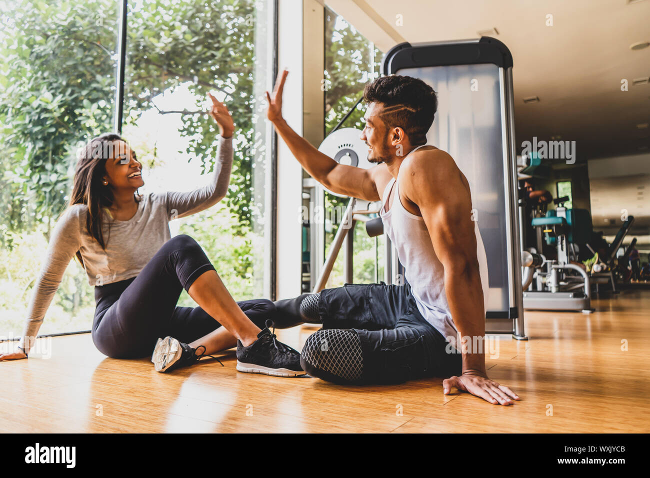 Couple training at gym, high five during pushups Stock Photo - Alamy