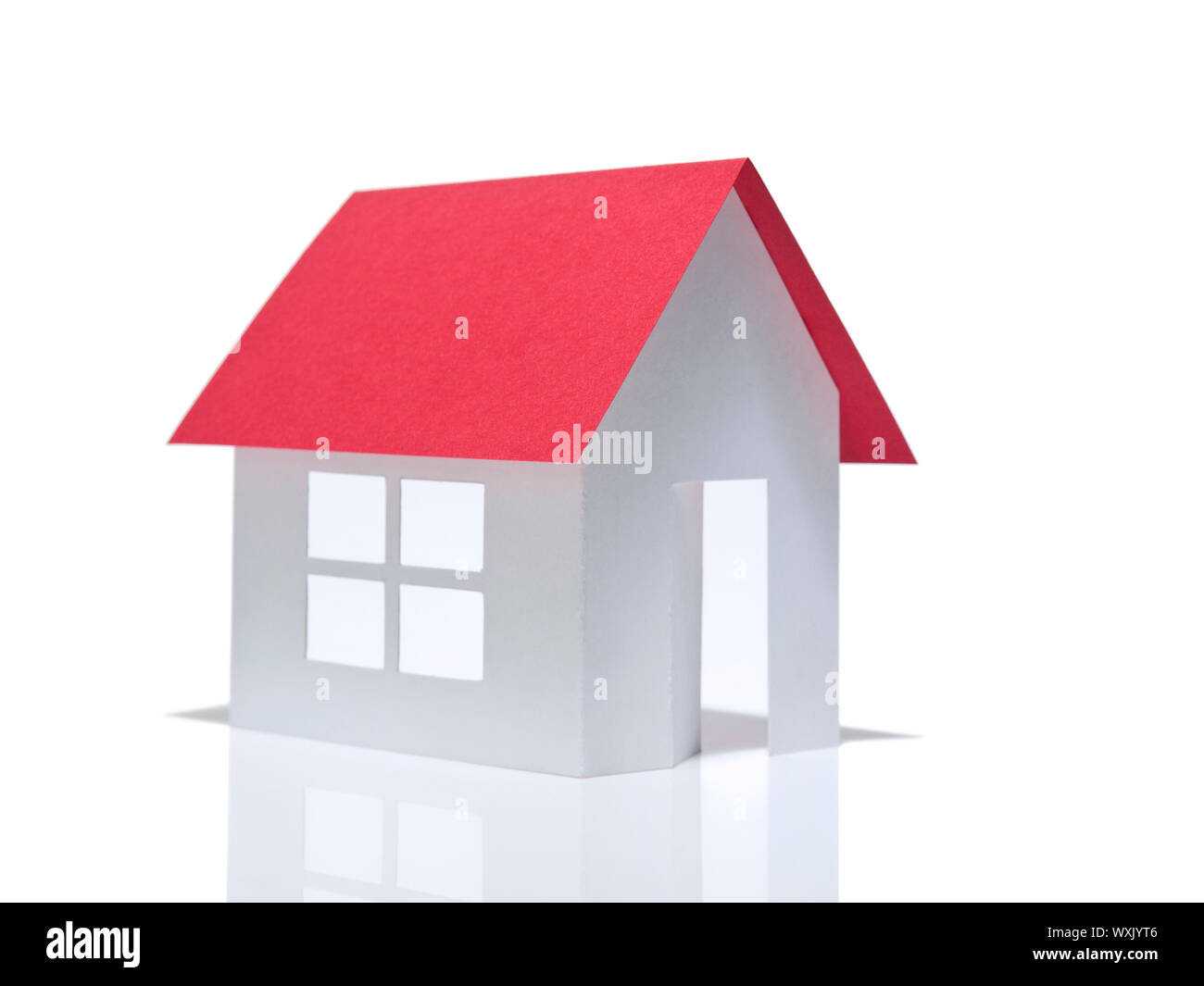 A paper house stands over a white background Stock Photo - Alamy