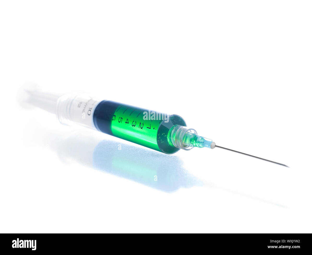 Close up on a syringe filled in with a green liquid Stock Photo - Alamy