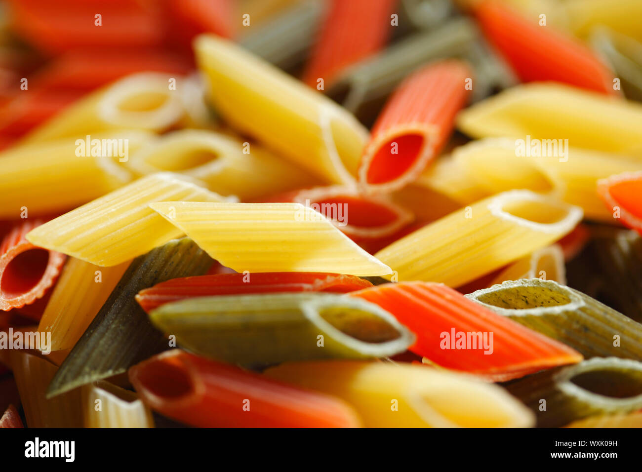 Colored dry italian pasta background Stock Photo - Alamy