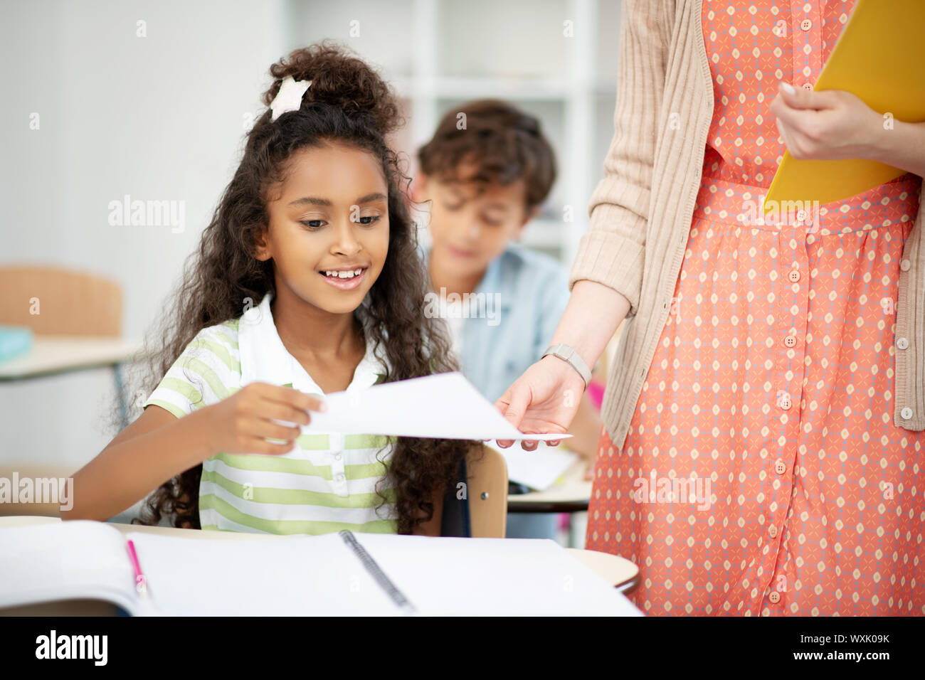 Curly schoolgirl feeling excited before seeing test results Stock Photo ...