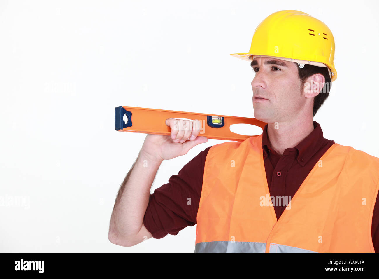 Mason with spirit level Stock Photo - Alamy