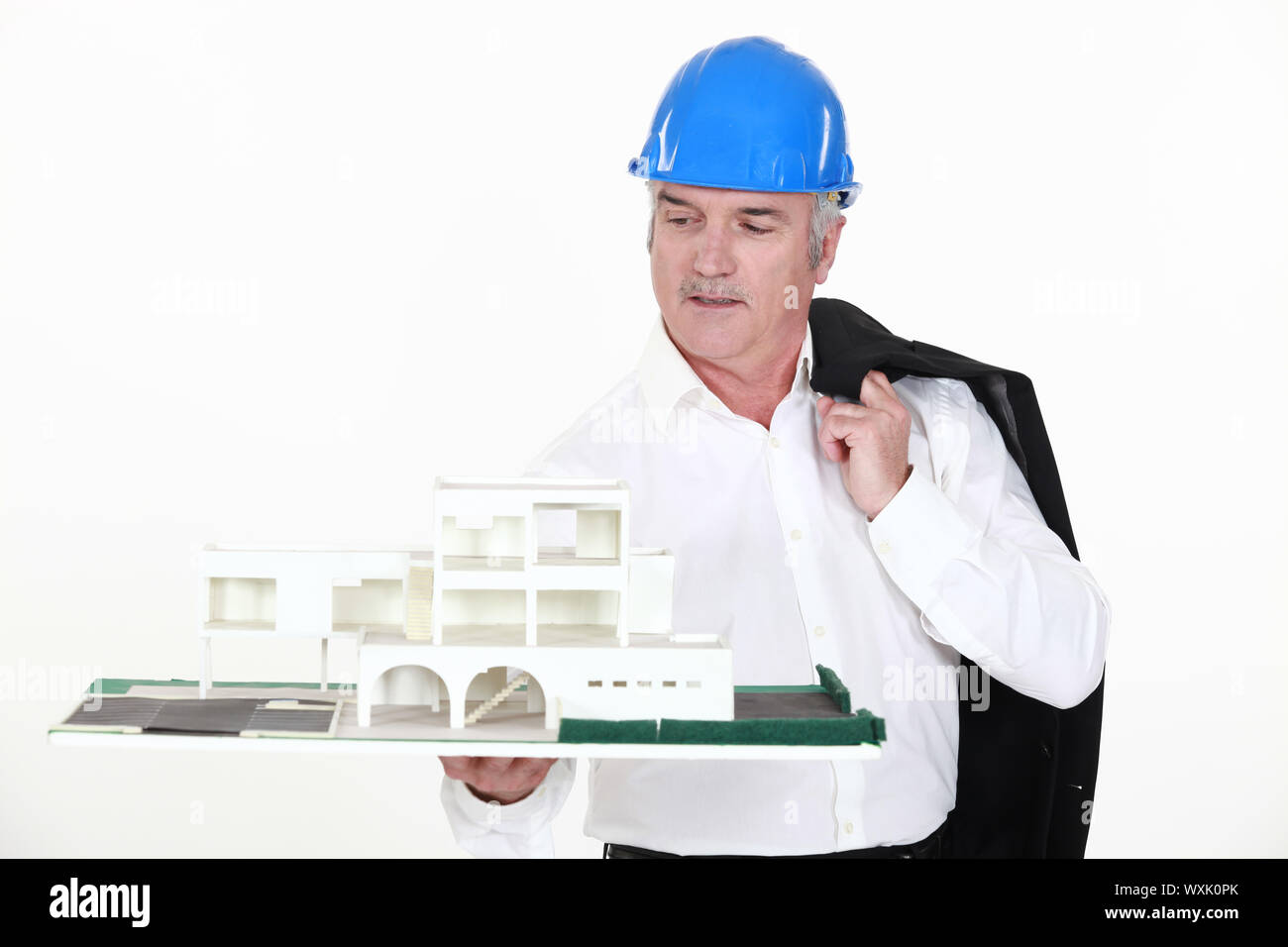 An architect holding a miniature Stock Photo - Alamy