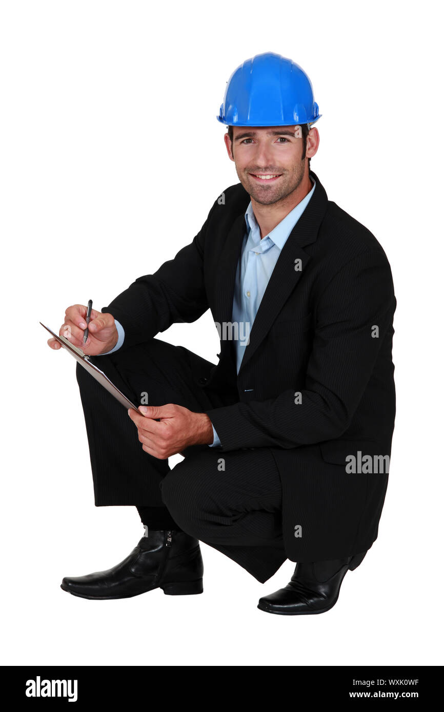 Engineer writing on a clipboard Stock Photo - Alamy