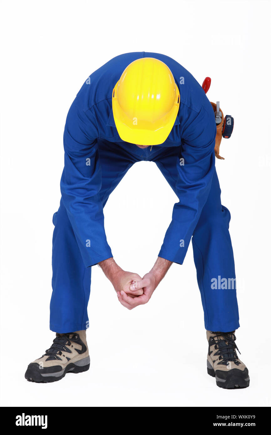 Worker bending over Stock Photo - Alamy