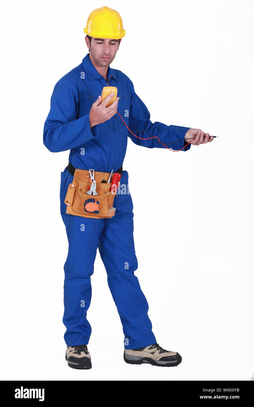 Tradesman using a multimeter Stock Photo - Alamy