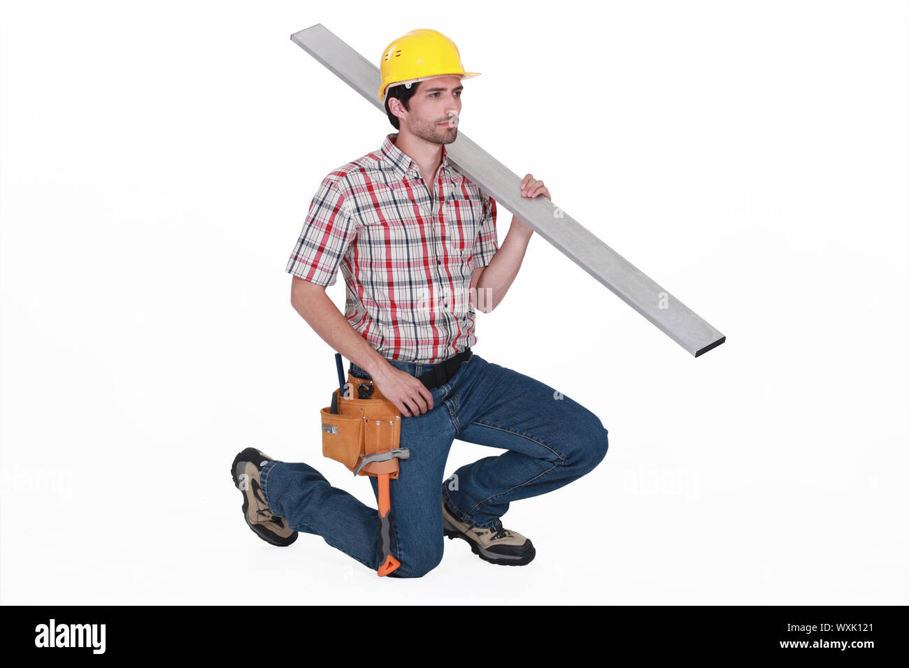 Worker kneeling down Stock Photo - Alamy