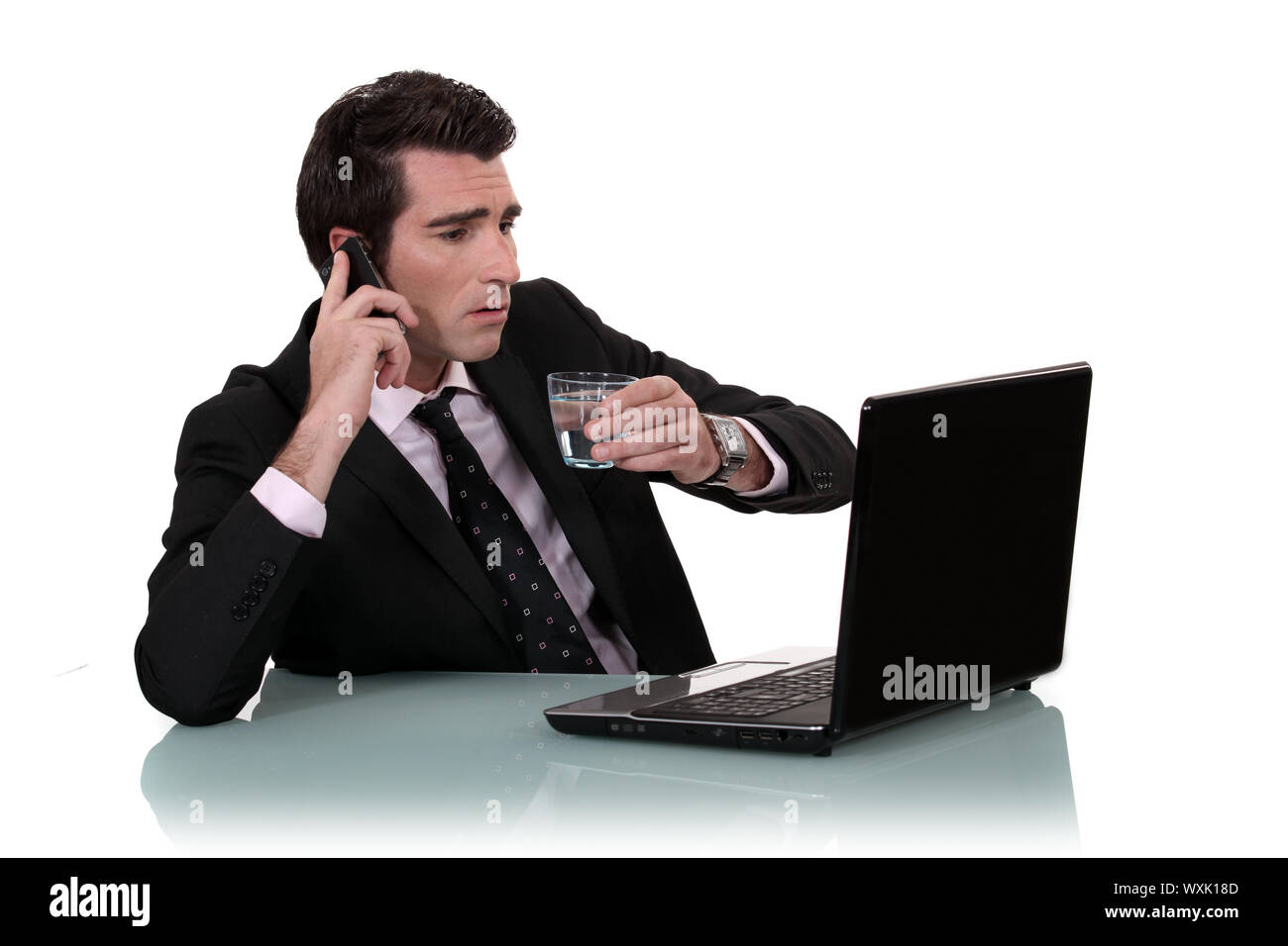 Businessman drinking water reading hi-res stock photography and images ...