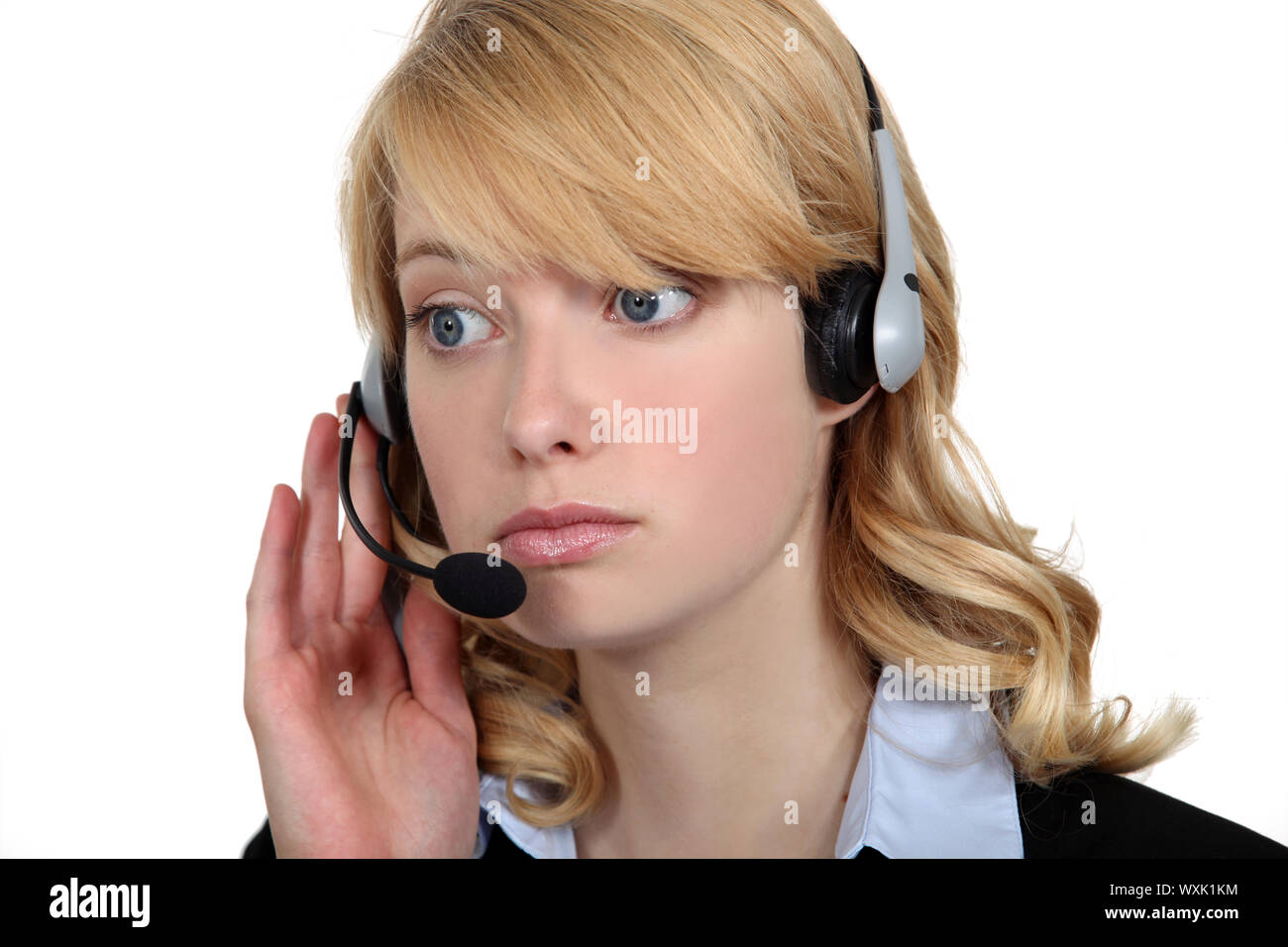 Blond call-center worker listening to customer Stock Photo - Alamy