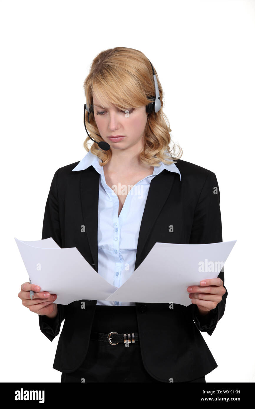 Businesswoman looking at paperwork Stock Photo - Alamy