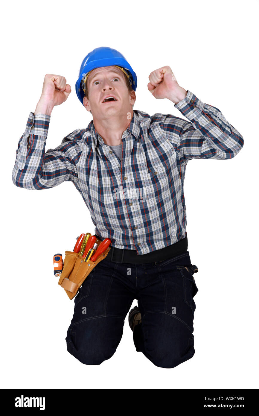 craftsman kneeling and thanking God Stock Photo - Alamy