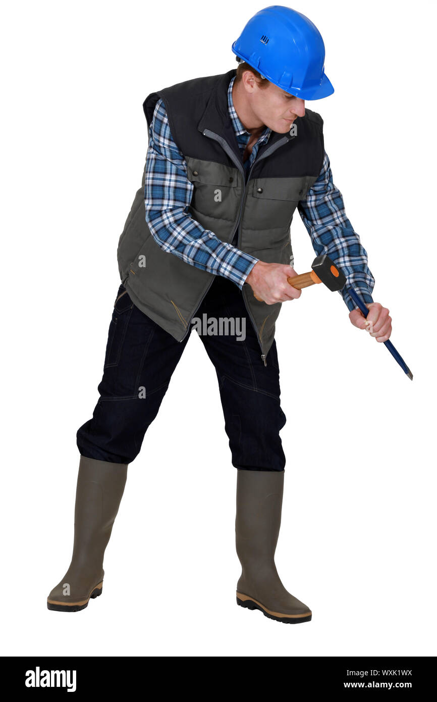 Laborer using hammer on white background Stock Photo - Alamy