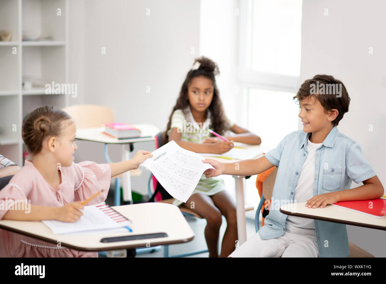 Boy sharing his homework with his best friend before the lesson Stock ...