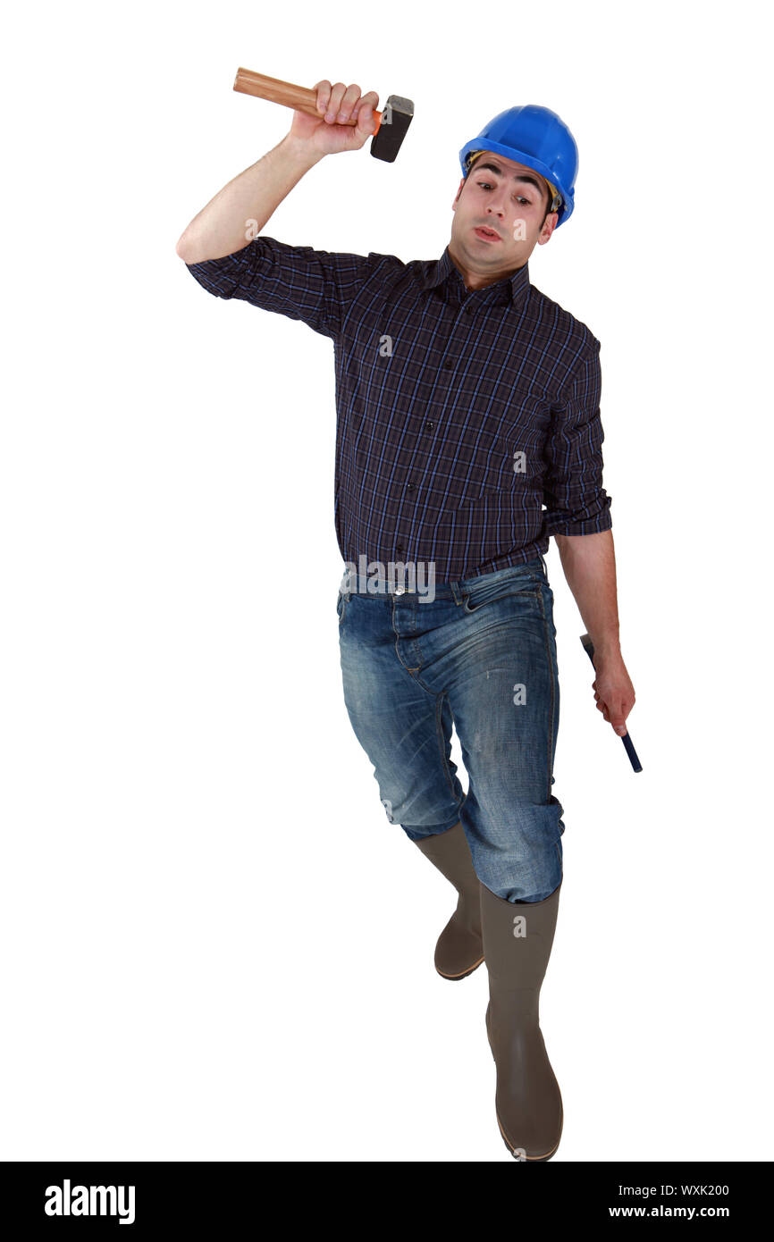 Builder lifting hammer over head Stock Photo - Alamy