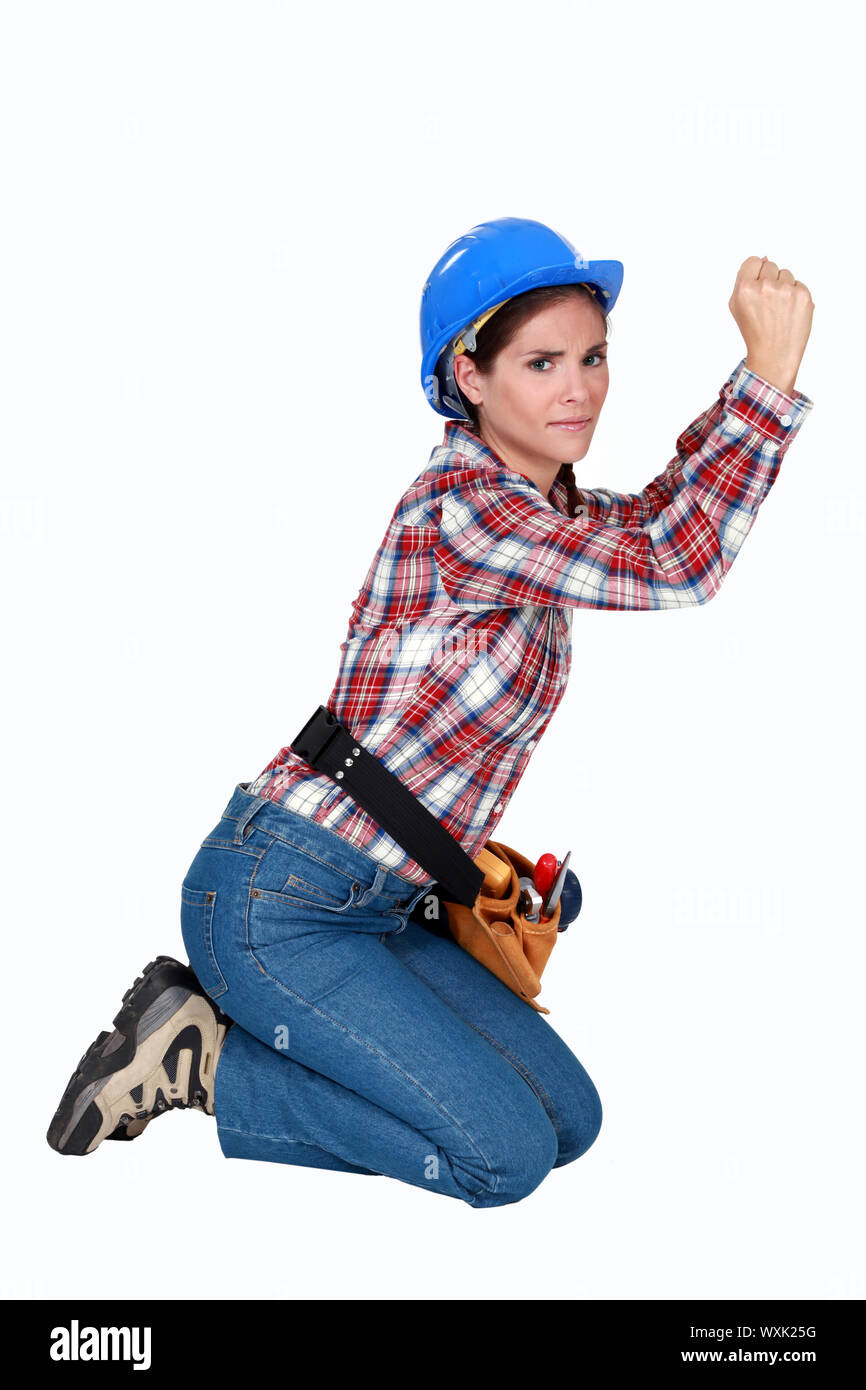 Female building worker kneeling on white background Stock Photo - Alamy