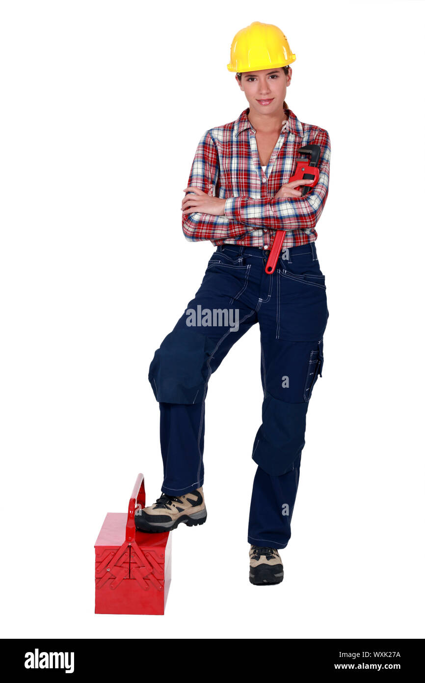 Female plumber standing on white background Stock Photo - Alamy