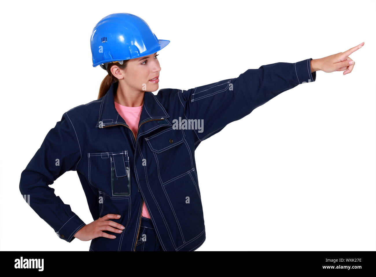 A female manual worker pointing at something Stock Photo - Alamy