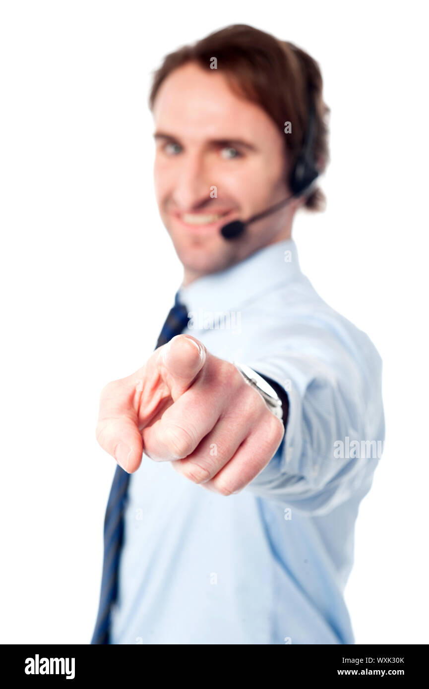 Customer support executive pointing towards you Stock Photo - Alamy