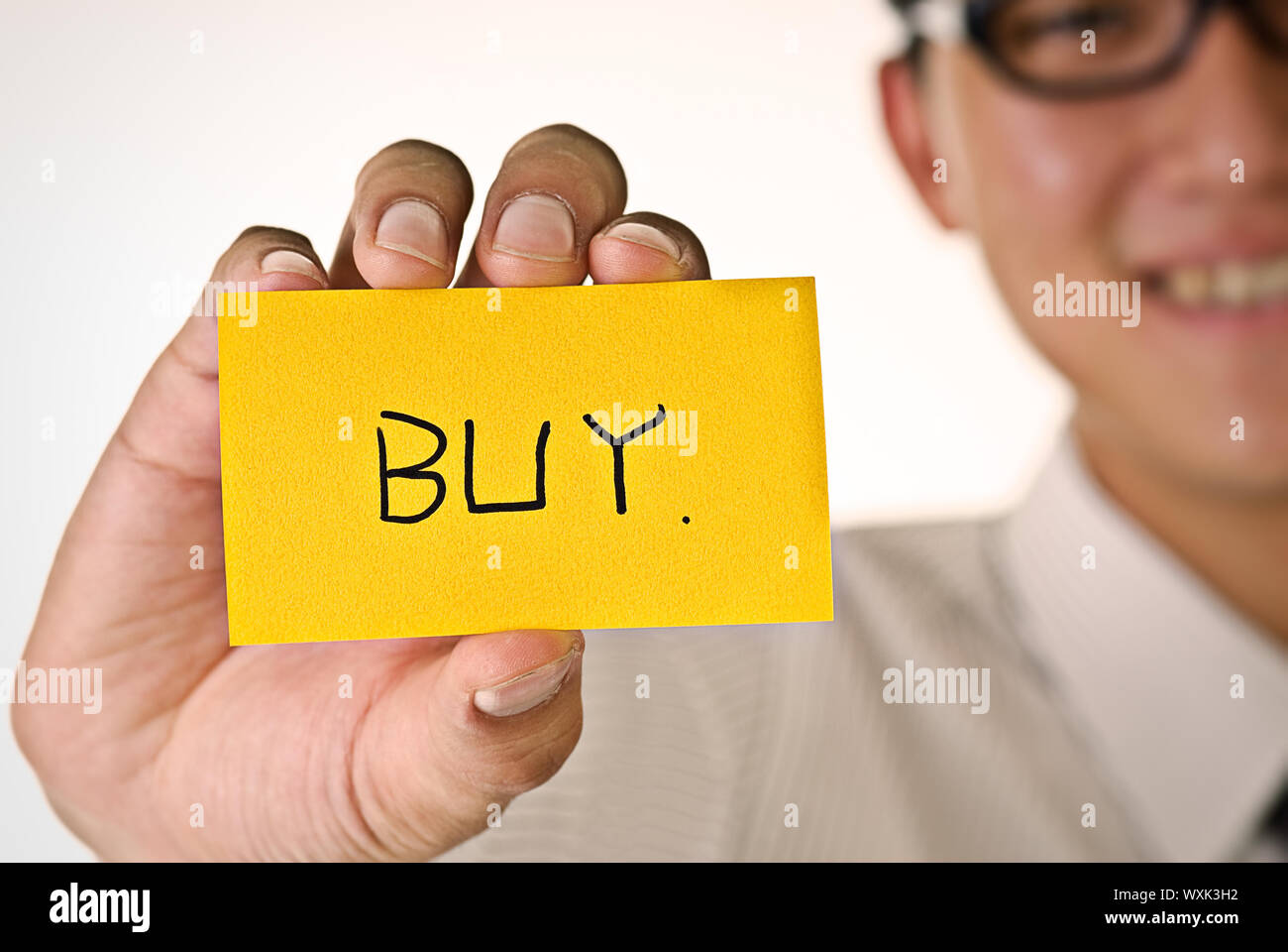 Buy words on yellow card hold by business man Stock Photo - Alamy
