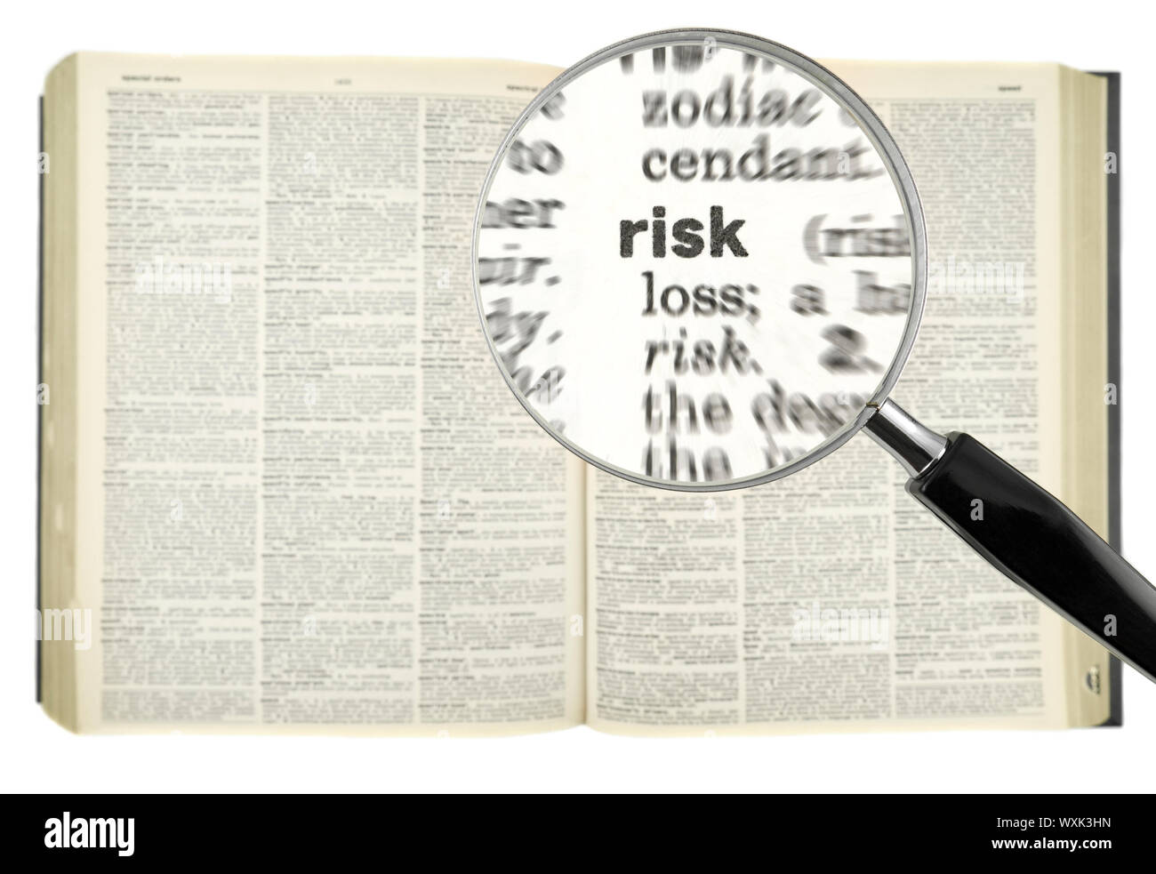 A magnifying glass on the word RISK on a dictionary Stock Photo - Alamy