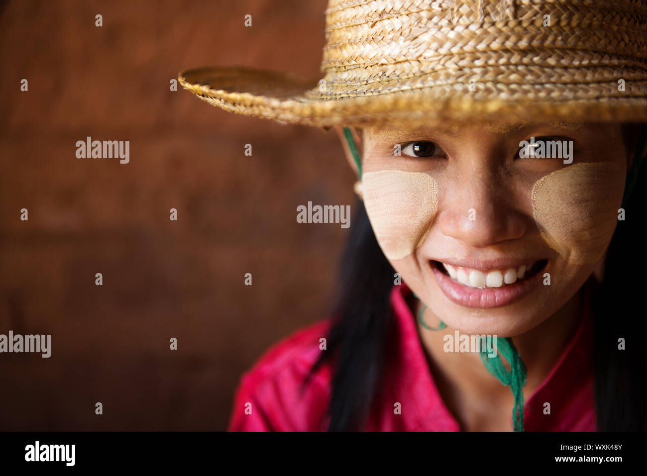 Portrait of beautiful young traditional Myanmar girl with straw hat ...