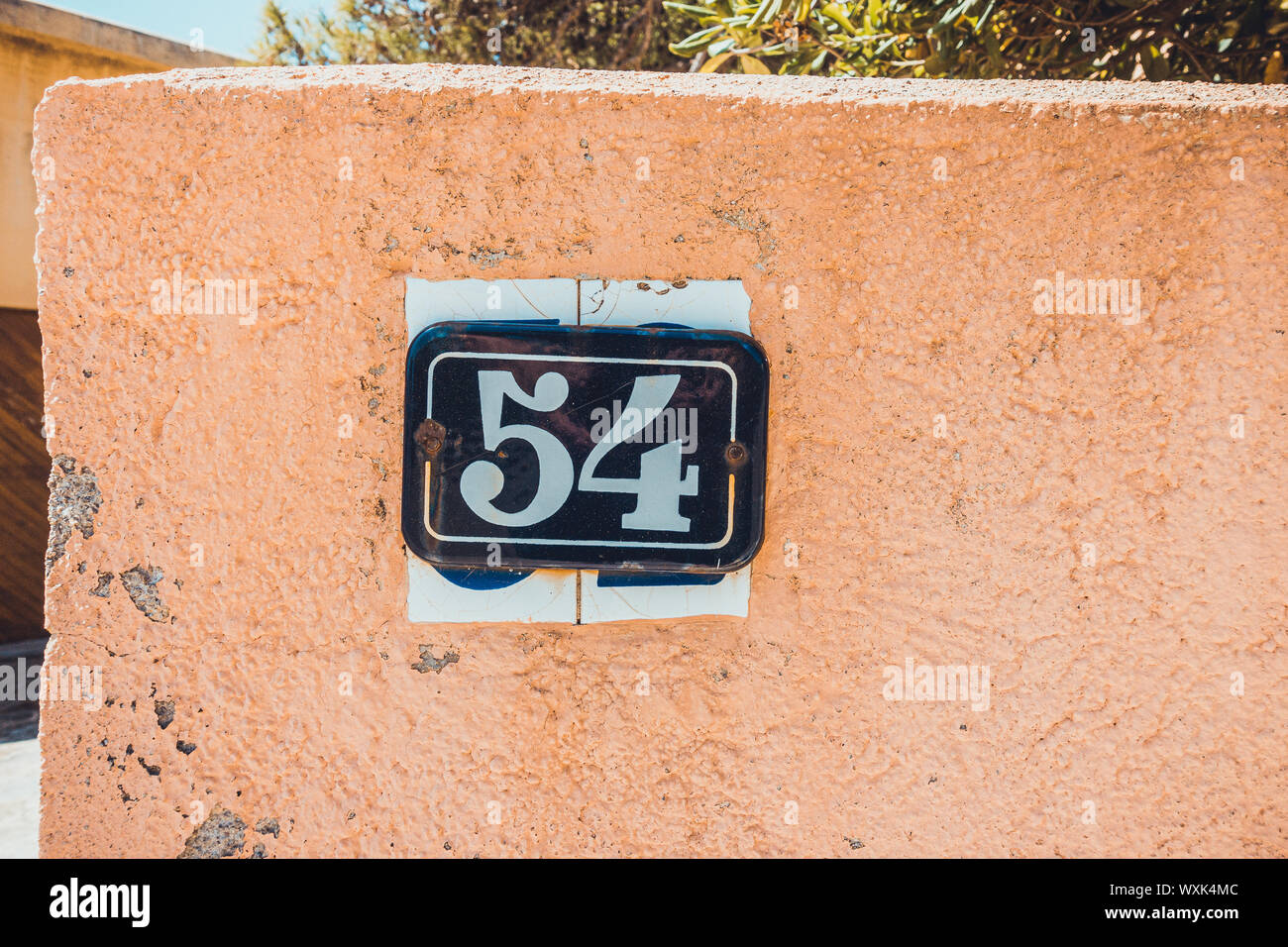 number 54 door sign with orange background Stock Photo - Alamy