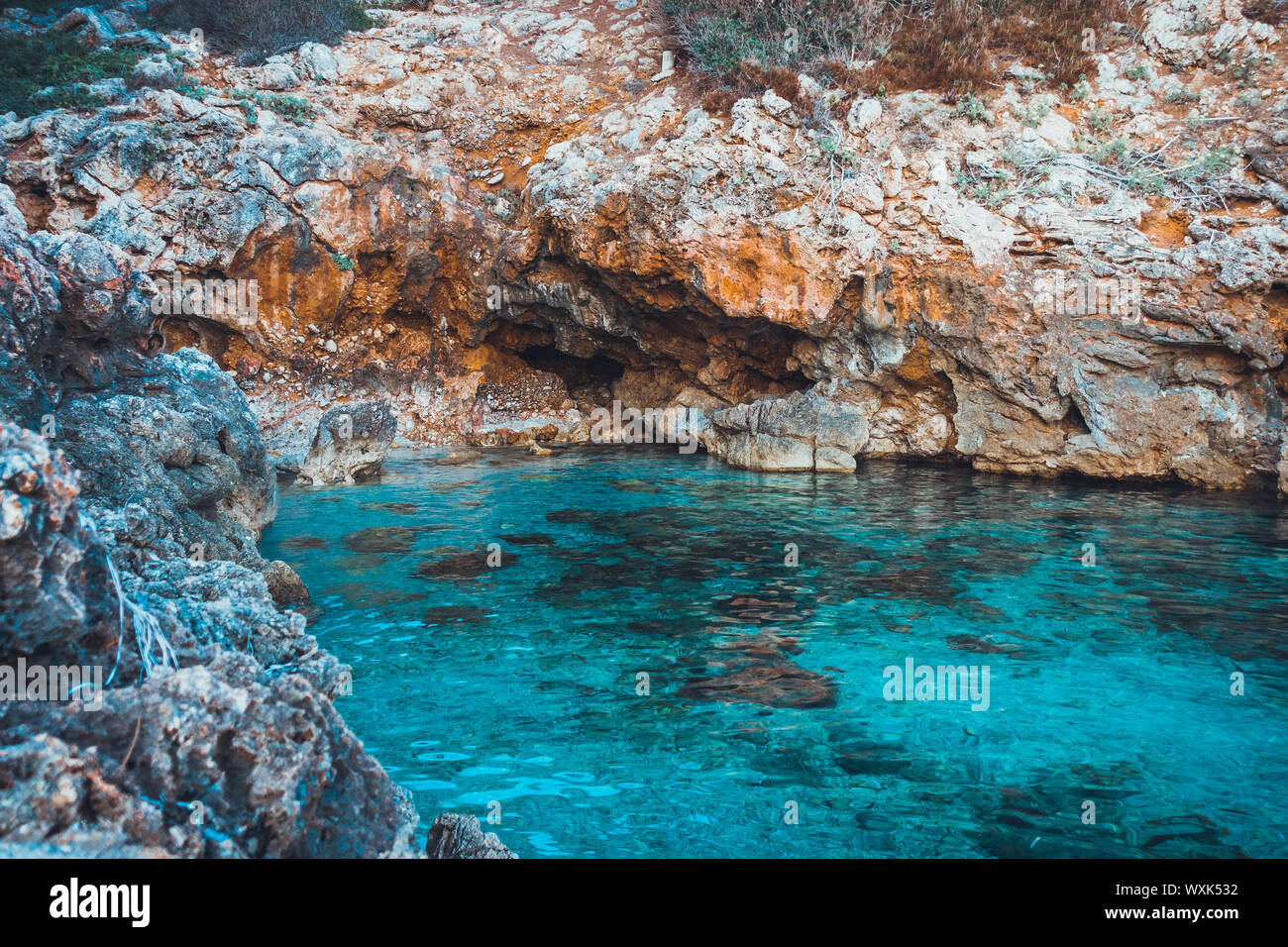 small cliff bay with blue clean water Stock Photo - Alamy