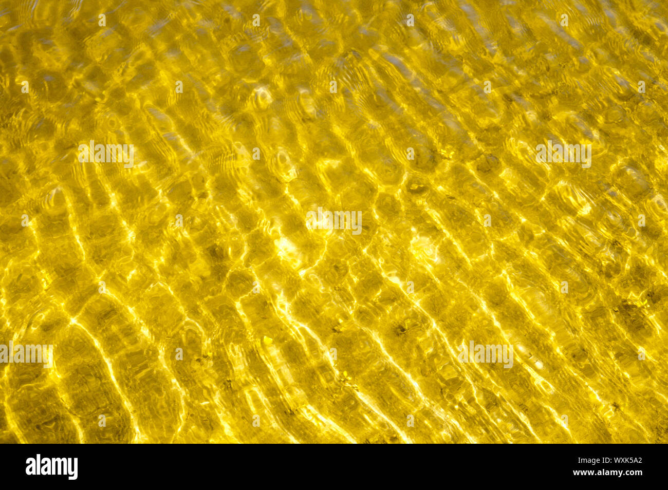 sand through wave of water Stock Photo - Alamy