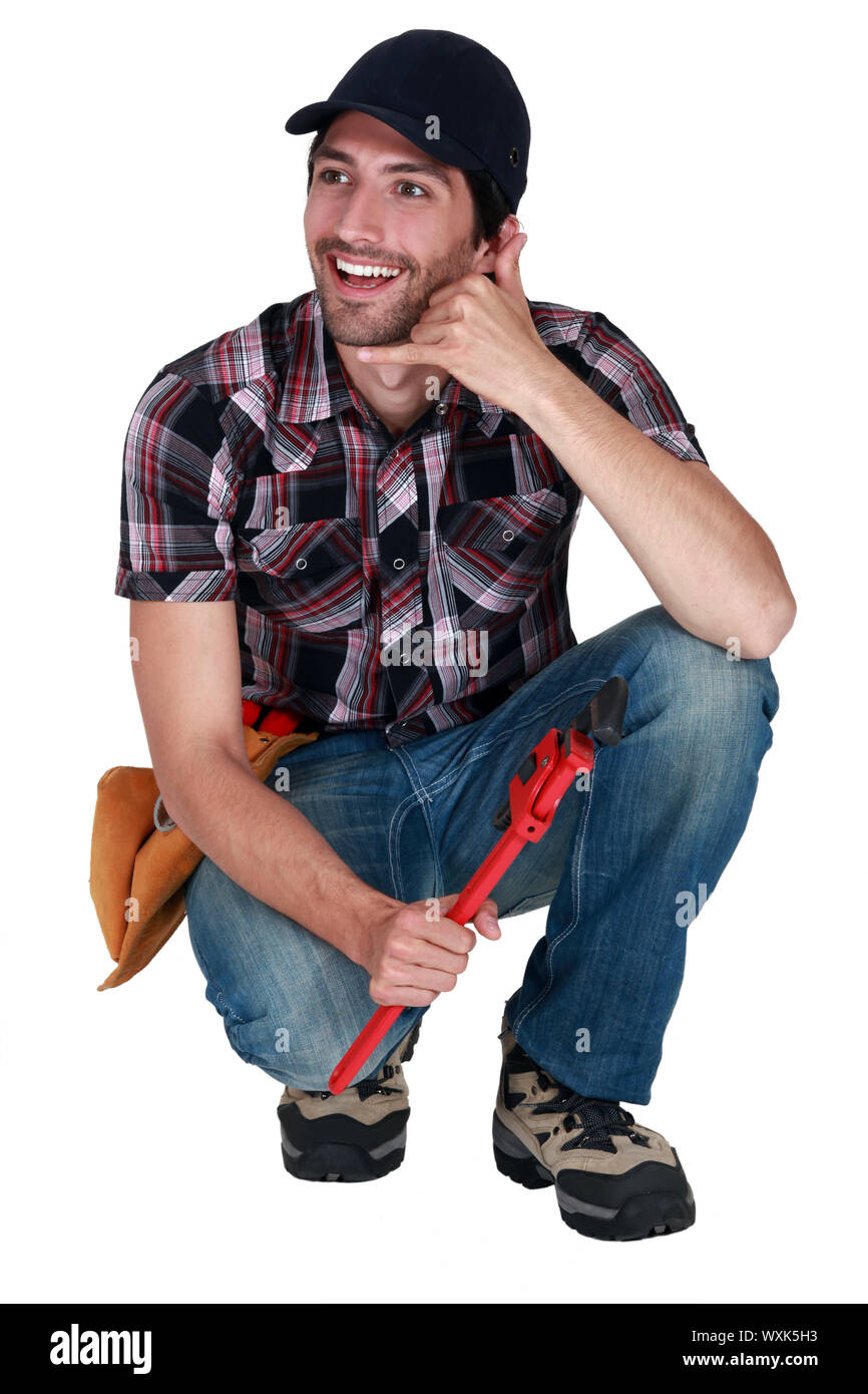 workman doing sign to make a phone call Stock Photo - Alamy