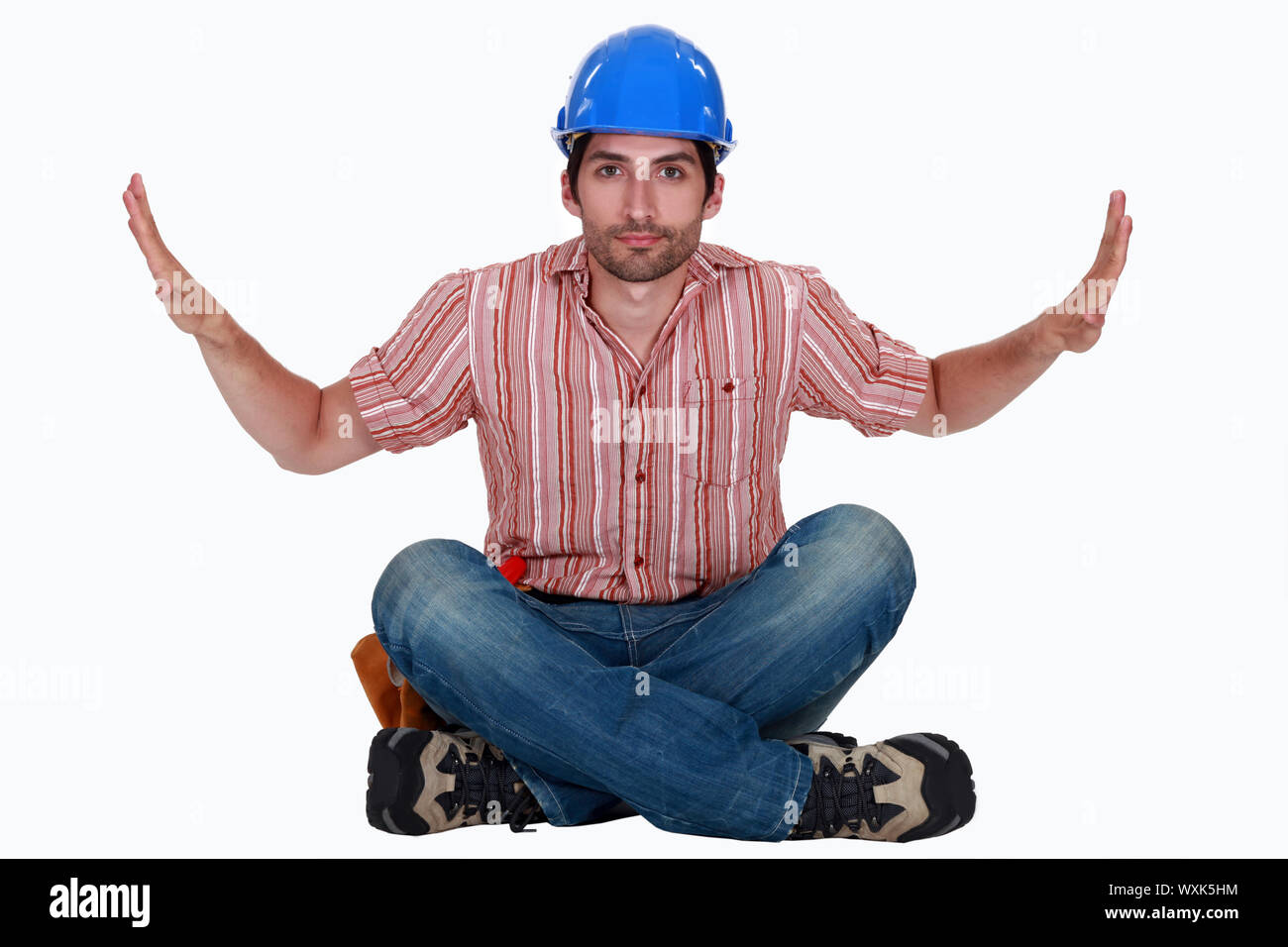 A seated construction worker Stock Photo - Alamy