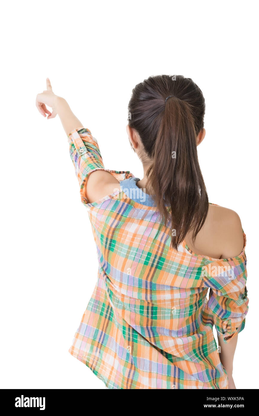 Asian woman points with finger at something in her back. Rear view ...
