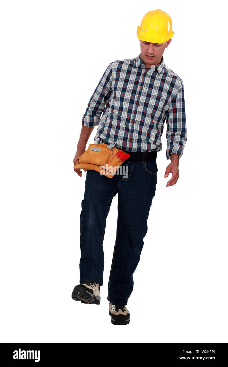 Laborer walking on white background Stock Photo - Alamy