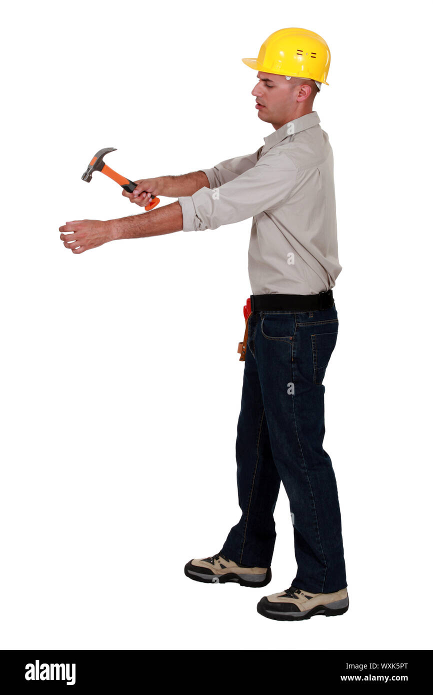 Man hammering an invisible object Stock Photo - Alamy