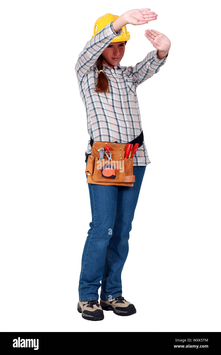 Female builder shielding face Stock Photo - Alamy