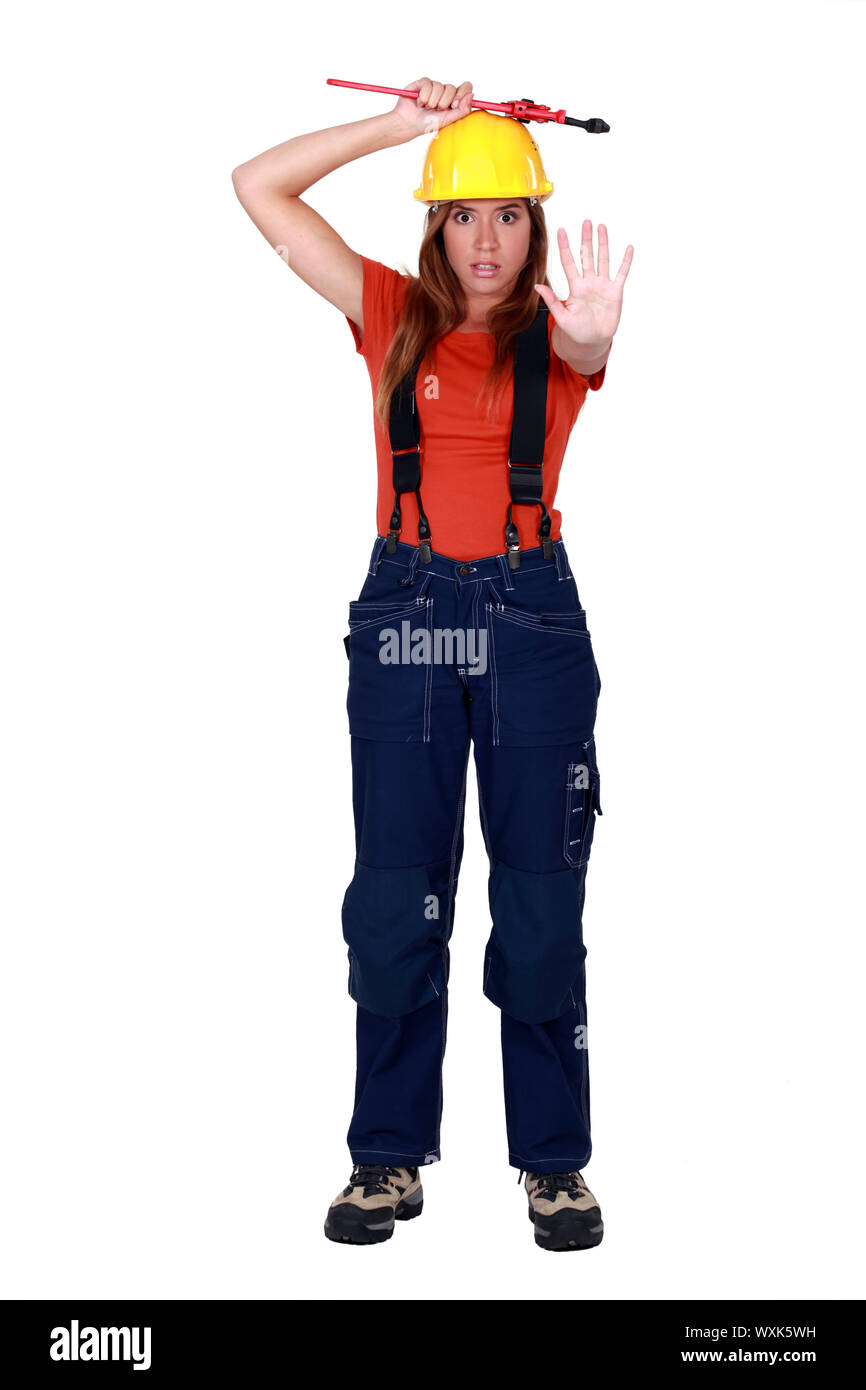 A female construction worker doing a stop sign Stock Photo - Alamy