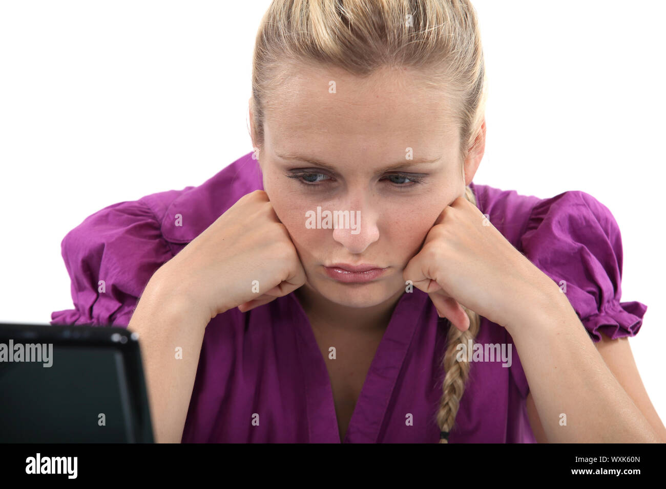 Employee pouting in front of her computer Stock Photo - Alamy